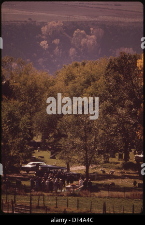 A somber funeral procession captured in the early 20th century ...
