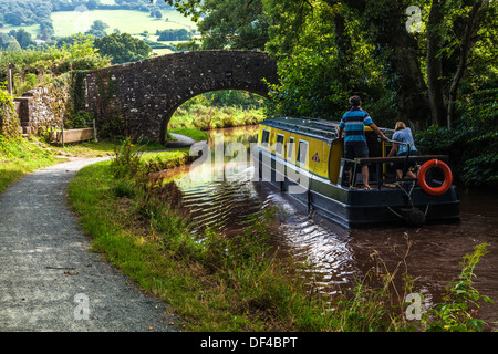 Canal boat passes under a bridge on the Trent and Mersey Canal near the ...