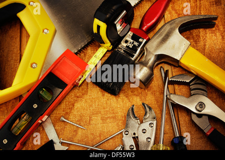 Assorted work tools on wooden table Stock Photo - Alamy