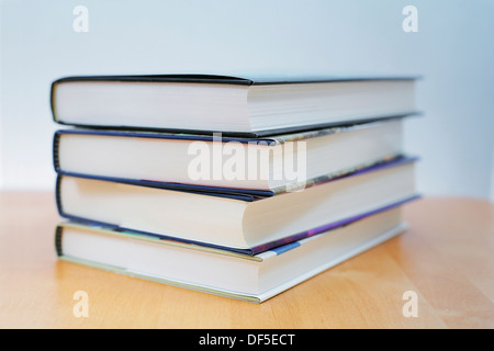 Stack of books on a wooden table Stock Photo - Alamy