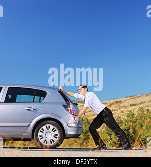 Businessman pushing a car with empty fuel tank Stock Photo - Alamy