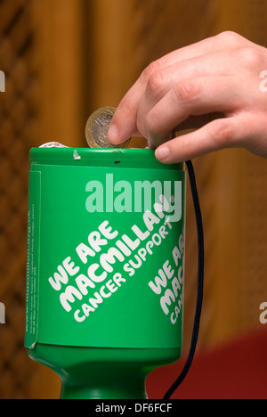 Making a £2 donation to Macmillan Cancer Support, Surrey, UK Stock ...