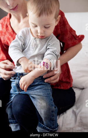 mother dressing her son Stock Photo - Alamy