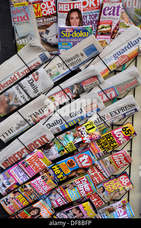 Newspapers and magazines on display on a shelf in a supermarket Stock ...