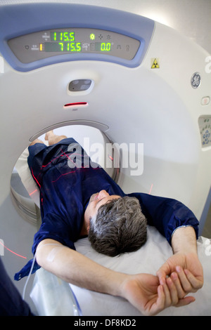 CT scan of abdomen of man in medical clinic. Man is doing computed ...