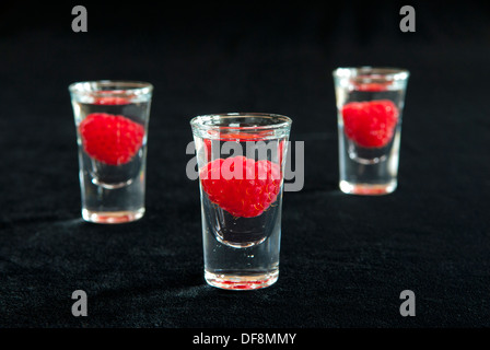 Raspberry shots on a black background Stock Photo - Alamy