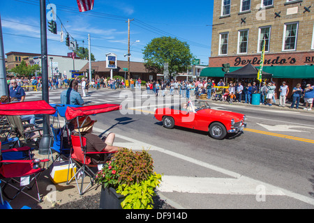 Vintage race cars driving though downtown Watkins Glen during the ...