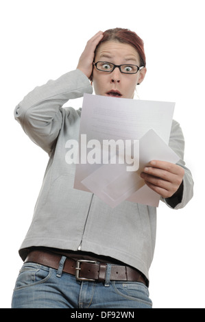 Shocked woman reading letter in living room Stock Photo - Alamy