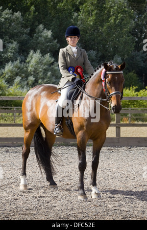 A competitor with their horse at an outdoor equestrian competition ...