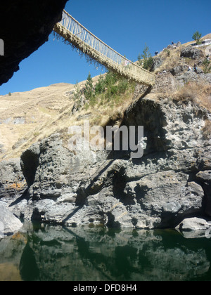 Qeswachaca Inca Bridge, a traditional woven grass rope bridge across ...