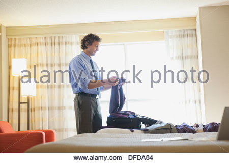 Packing suitcase in hotel room at end vacations. Untidy room with Stock ...