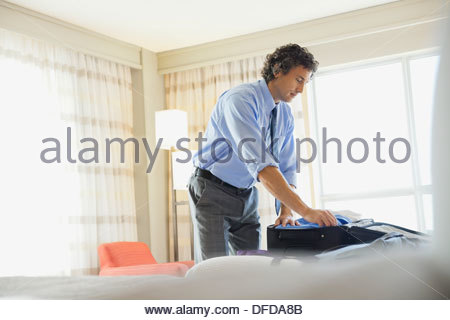 Packing suitcase in hotel room at end vacations. Untidy room with Stock ...