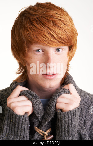 Young handsome redhead man wearing casual t-shirt over isolated red ...