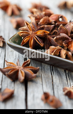 Star anise on a wooden table, closeup Stock Photo - Alamy