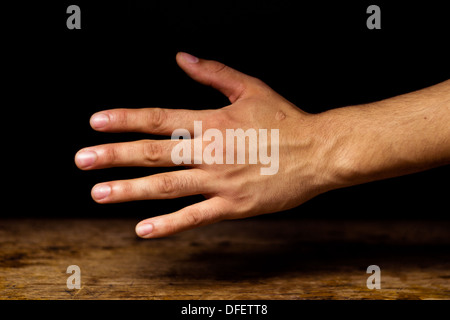 The left male hand with the back of the hand with spread fingers on a ...