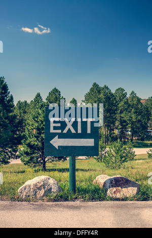 Parking lot exit sign with arrow against a blue sky Stock Photo - Alamy