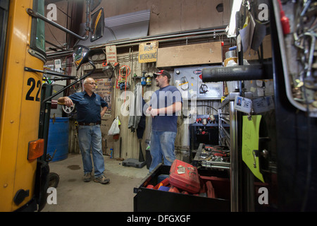 School Bus Mechanic Talks with His Union Representative Stock Photo - Alamy