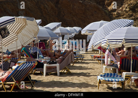 Beach umbrellas and Sunbathers at Panormos, Crete, Greece Stock Photo ...