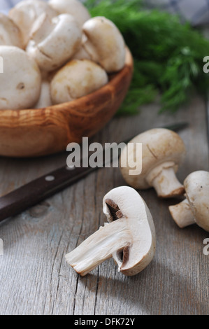 raw champignon mushroom on a chopping board on table Stock Photo - Alamy