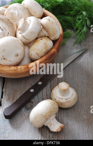 raw champignon mushroom on a chopping board on table Stock Photo - Alamy