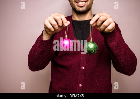 happy young man holding christmas present and smiling at camera Stock ...