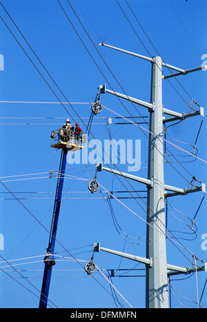Workers installing power lines Stock Photo - Alamy