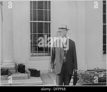 A photograph shows Secretary of War Henry Stimson leaving the White ...