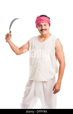 Happy Indian farmer Holding sickle and Paddy crop in hand - Concept good crop yields due to ...