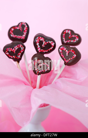 Chocolate cake pops on pink background. Selective focus.Chocolate cake ...