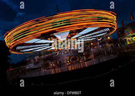 Fairground carnival rides at night time Stock Photo - Alamy