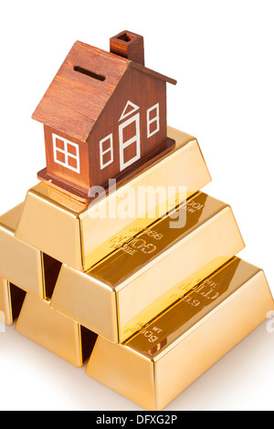 Gold bricks and model house Stock Photo - Alamy