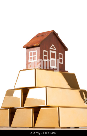 Gold bricks and model house Stock Photo - Alamy