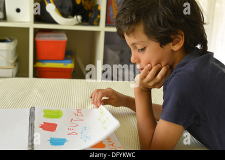 Boy watching his sketchbook Stock Photo - Alamy