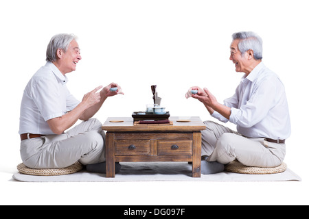 Male senior friends chatting over tea Stock Photo - Alamy