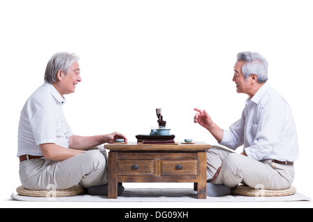 Male senior friends chatting over tea Stock Photo - Alamy