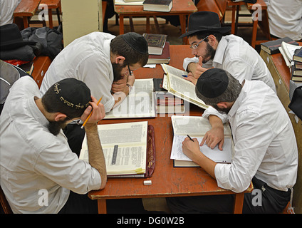 A group of religious Jewish boys studying together at a synagogue in ...