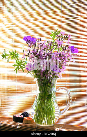 A bouquet of wild flowers on the windowsill in a vase. Front view Stock ...