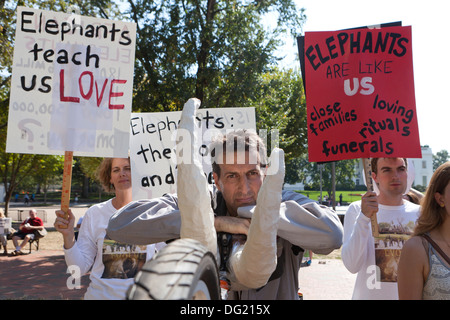 Elephant March demonstrators holding up signs protesting against ...