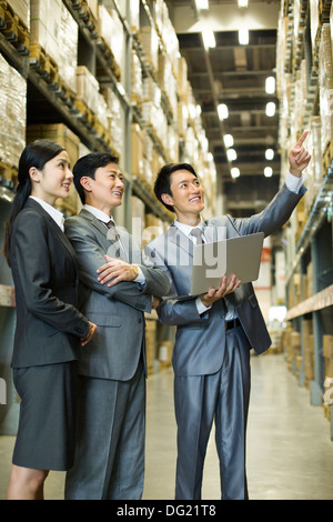 warehouse manager holding a laptop Stock Photo - Alamy