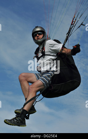 Pilot sitting in paraglider seat high in the sky Stock Photo - Alamy