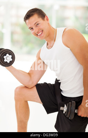 Happy man working out with dumbbells over gray background Stock Photo ...