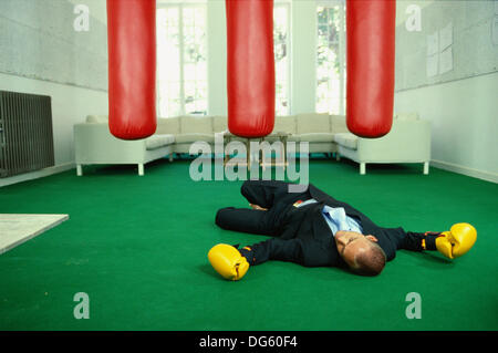 Beaten man lying on the floor of the boxing ring during the knockout ...
