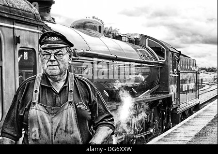 Mayflower steam engine with engineer stood in front Stock Photo - Alamy
