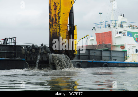 dredger ship digging at Santos (Sao Paulo, Brazil) port channel to make ...