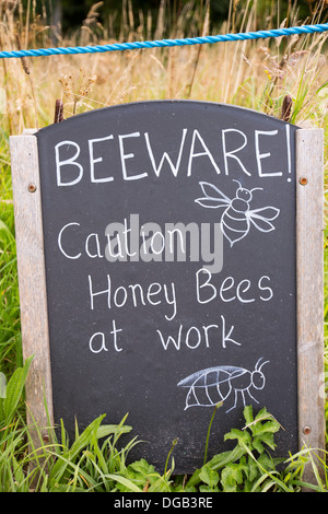A bee hive with a warning sign Stock Photo - Alamy