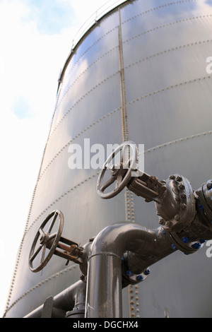Low angle view of industrial piping and storage tanks at biofuel plant ...