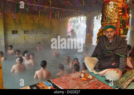 Hindu pilgrims bathing in hot springs below the Badrinath temple, India ...