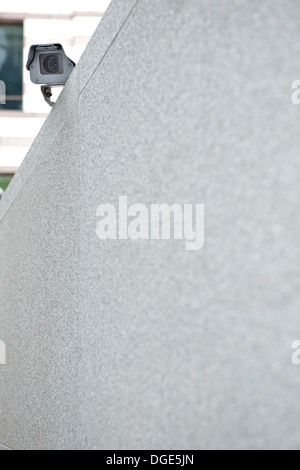 CCTV camera on gray wall close up Stock Photo - Alamy