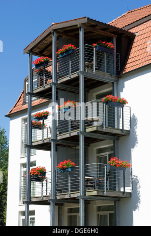 Modern apartment building facade with white walls, large windows and ...
