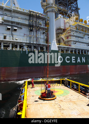 crew members of oil rig been transported on a basket to a supply ...